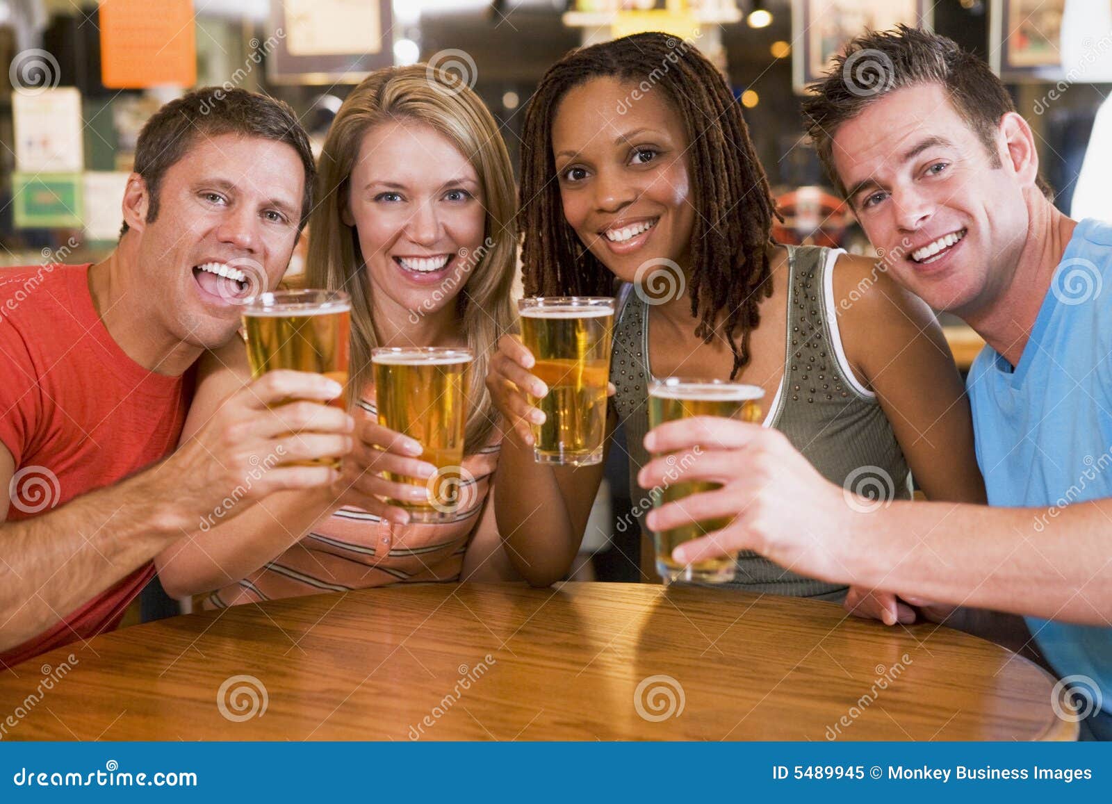 Group of Young Friends in Bar Toasting the Camera Stock Image - Image ...