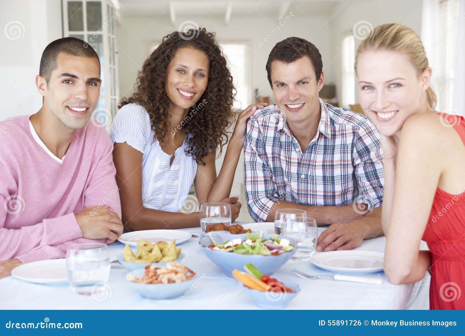 Group of Young Friends Eating Meal at Home Stock Photo - Image of table ...