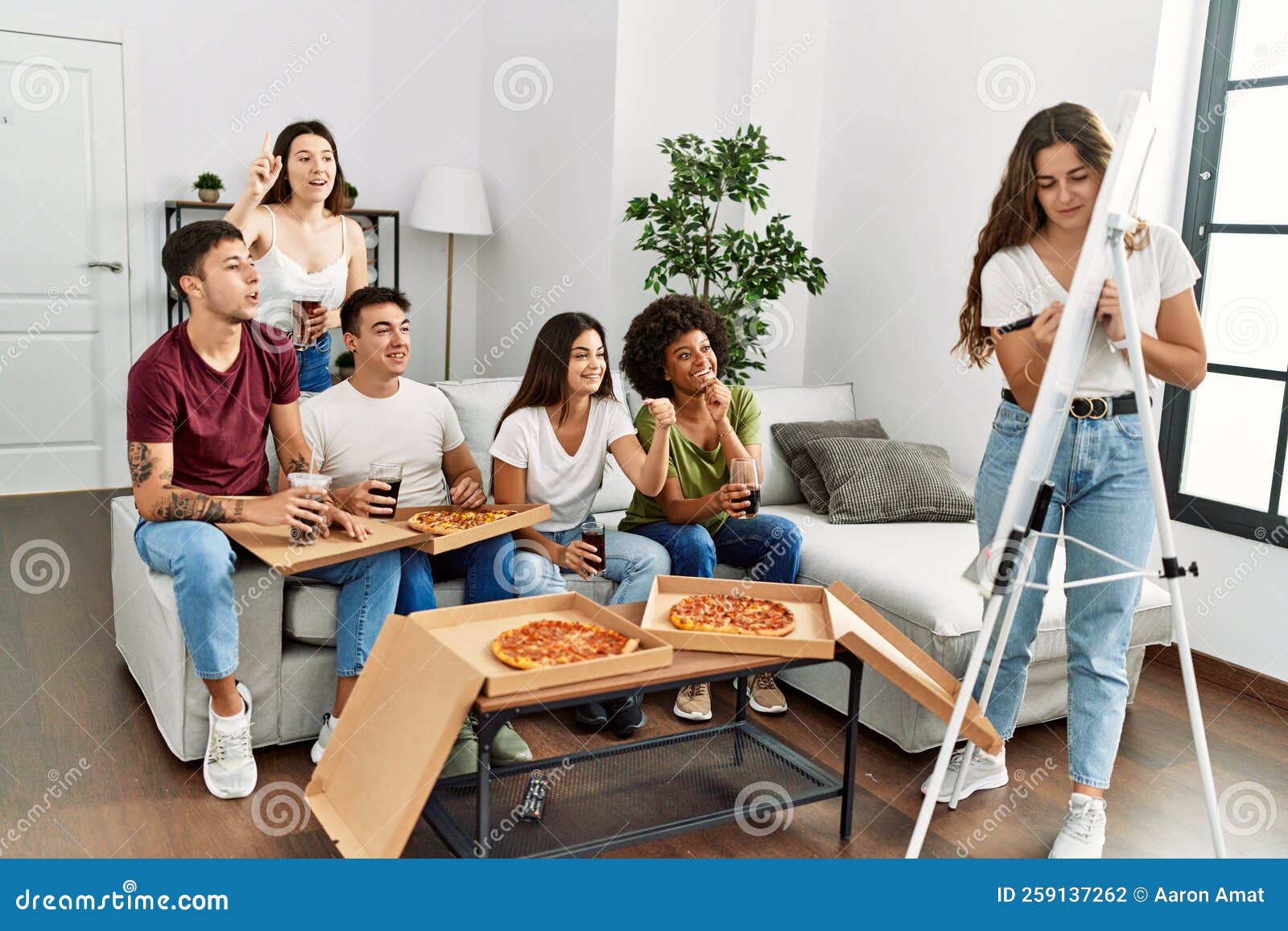 Group of Young Friends Eating Pizza and Playing Draw Game at Home Stock ...