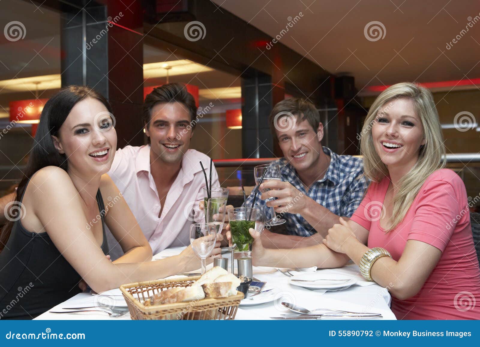 Group of Young Friends Enjoying Meal in Restaurant Stock Photo - Image ...