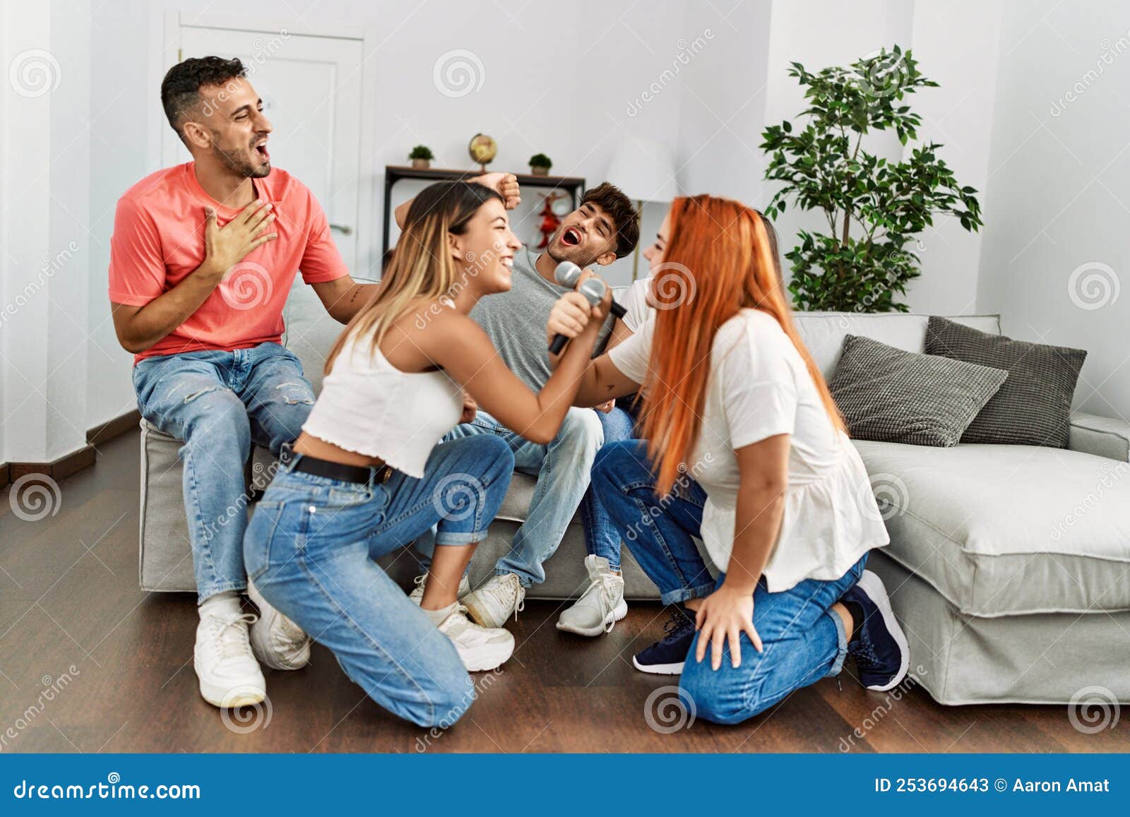 Group of Young Friends Having Party Singing Song Using Microphone at ...