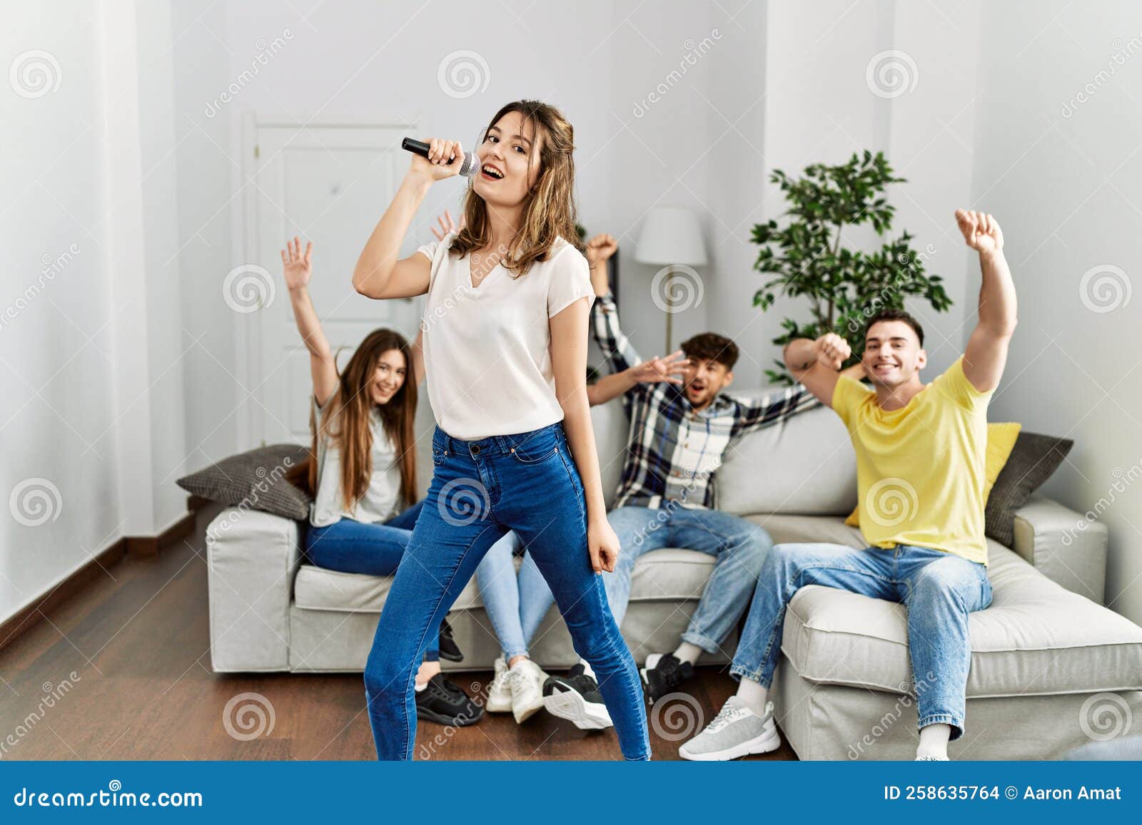 Group of Young Friends Having Party Singing Song Using Microphone at ...