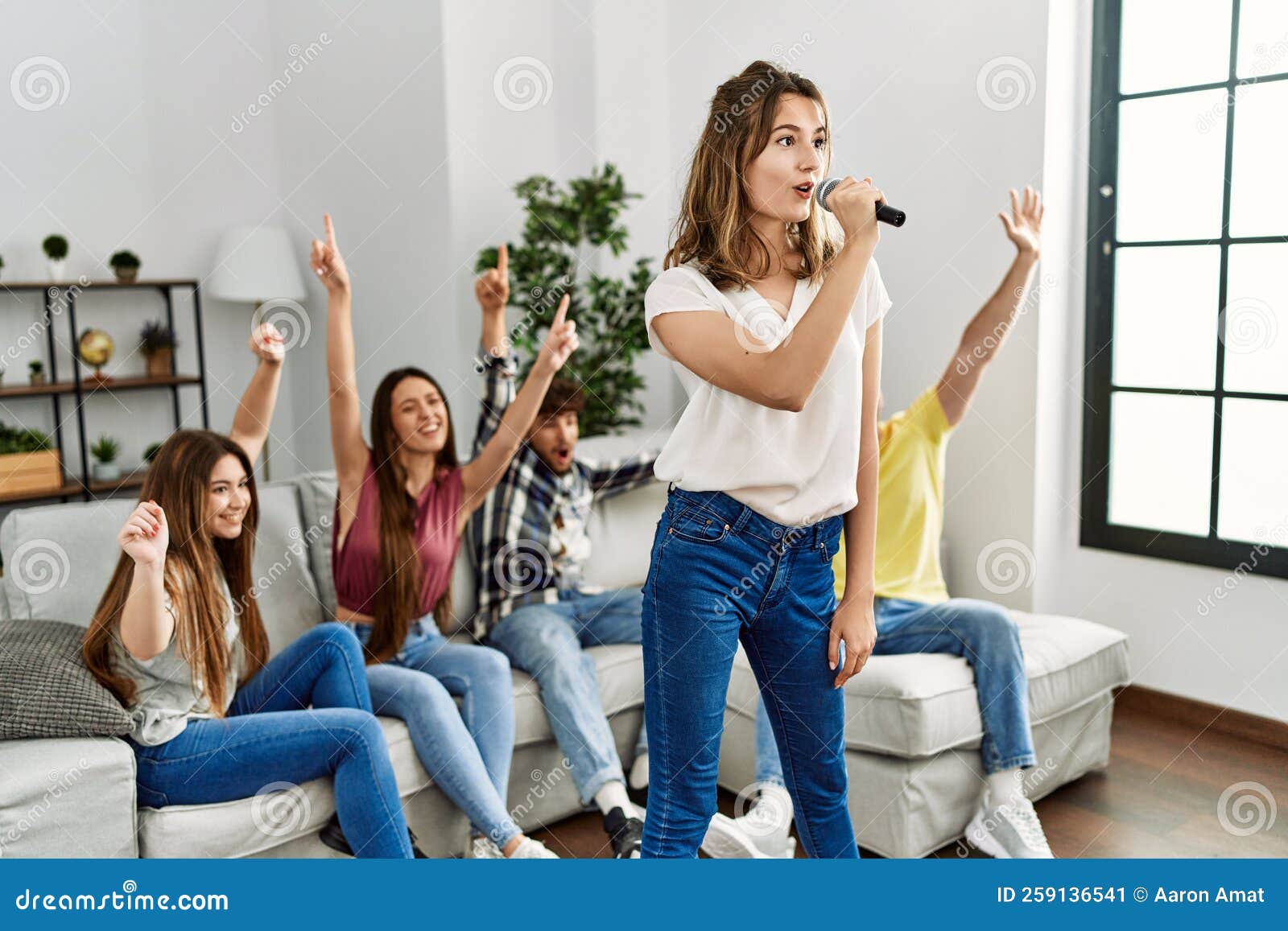 Group of Young Friends Having Party Singing Song Using Microphone at ...