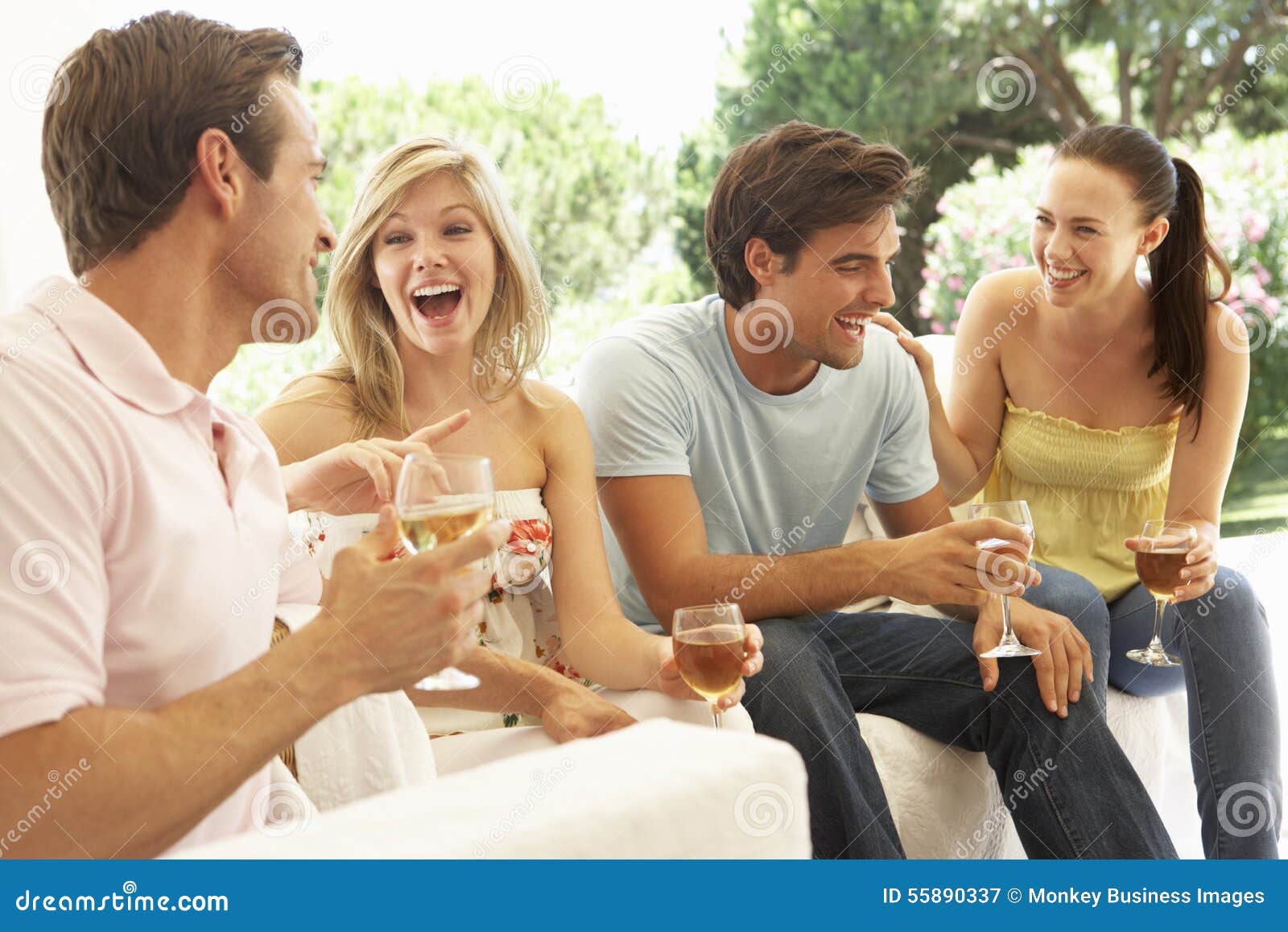 Group of Young Friends Relaxing on Sofa Drinking Wine Together Stock ...