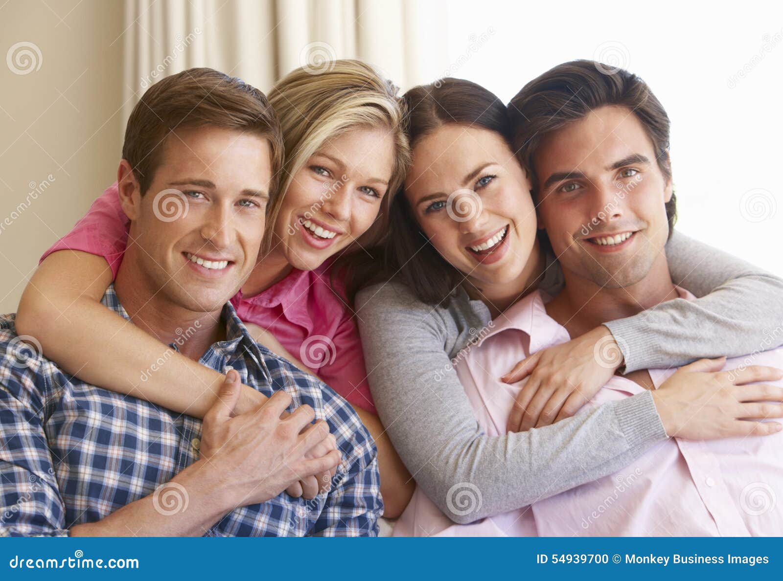 Group of Young Friends Relaxing on Sofa Together at Home Stock Photo ...