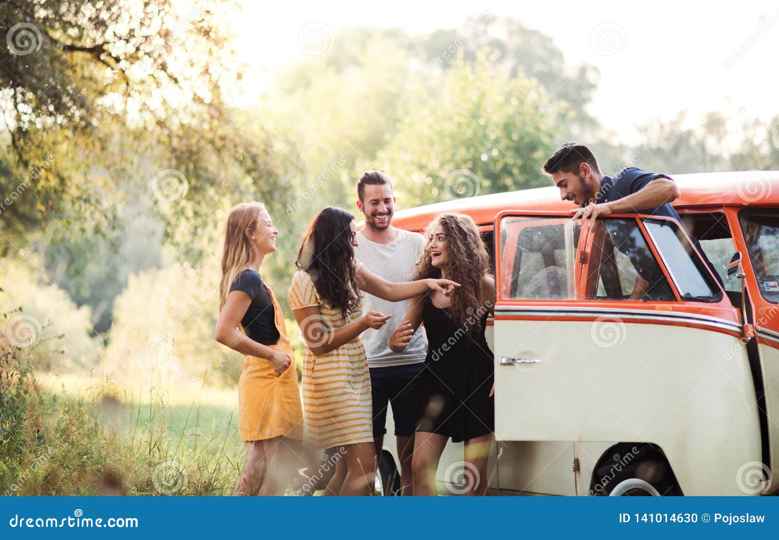 A Group of Young Friends on a Roadtrip through Countryside. Stock Photo ...