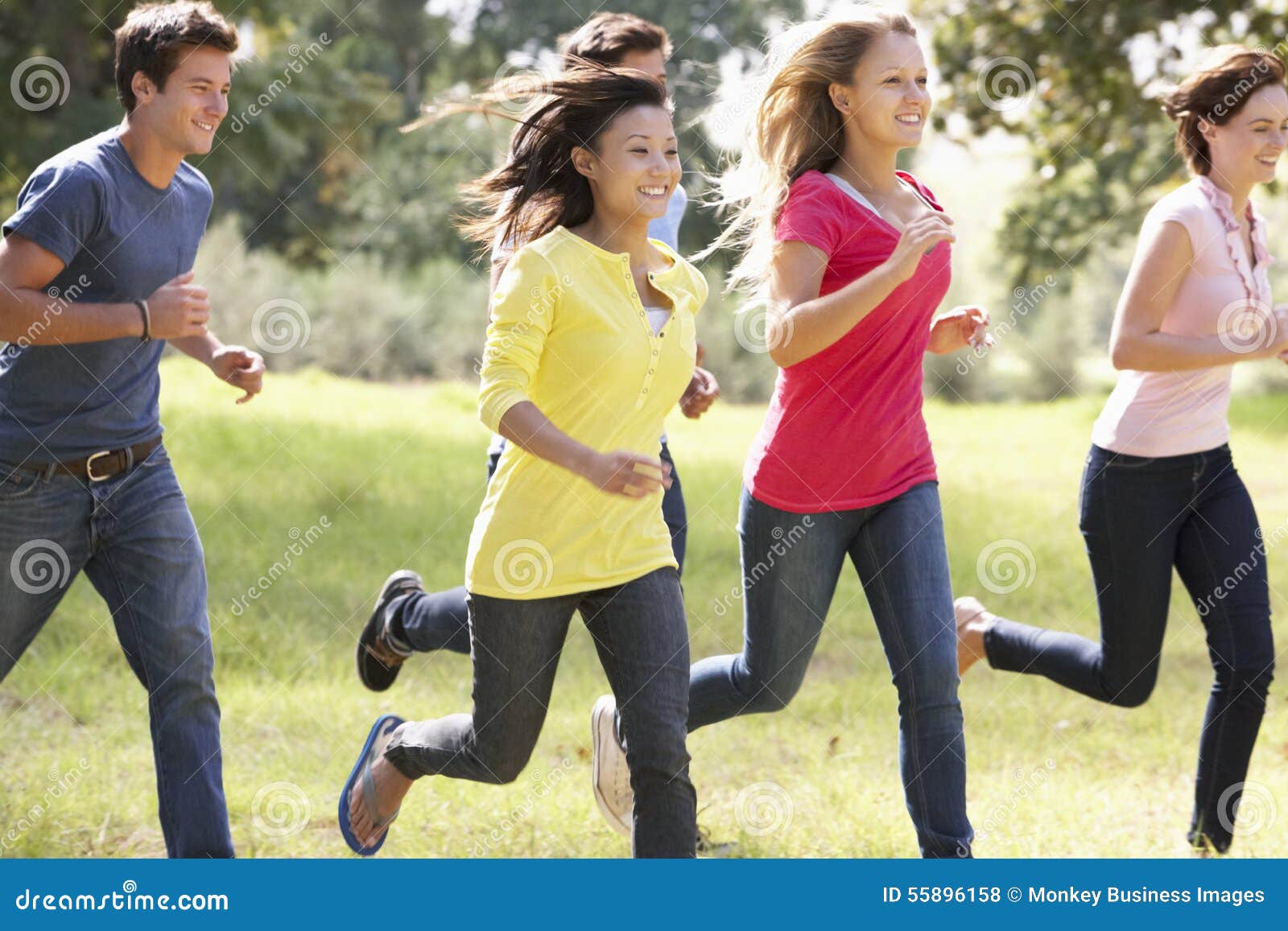 Group of Young Friends Running through Countryside Stock Photo - Image ...