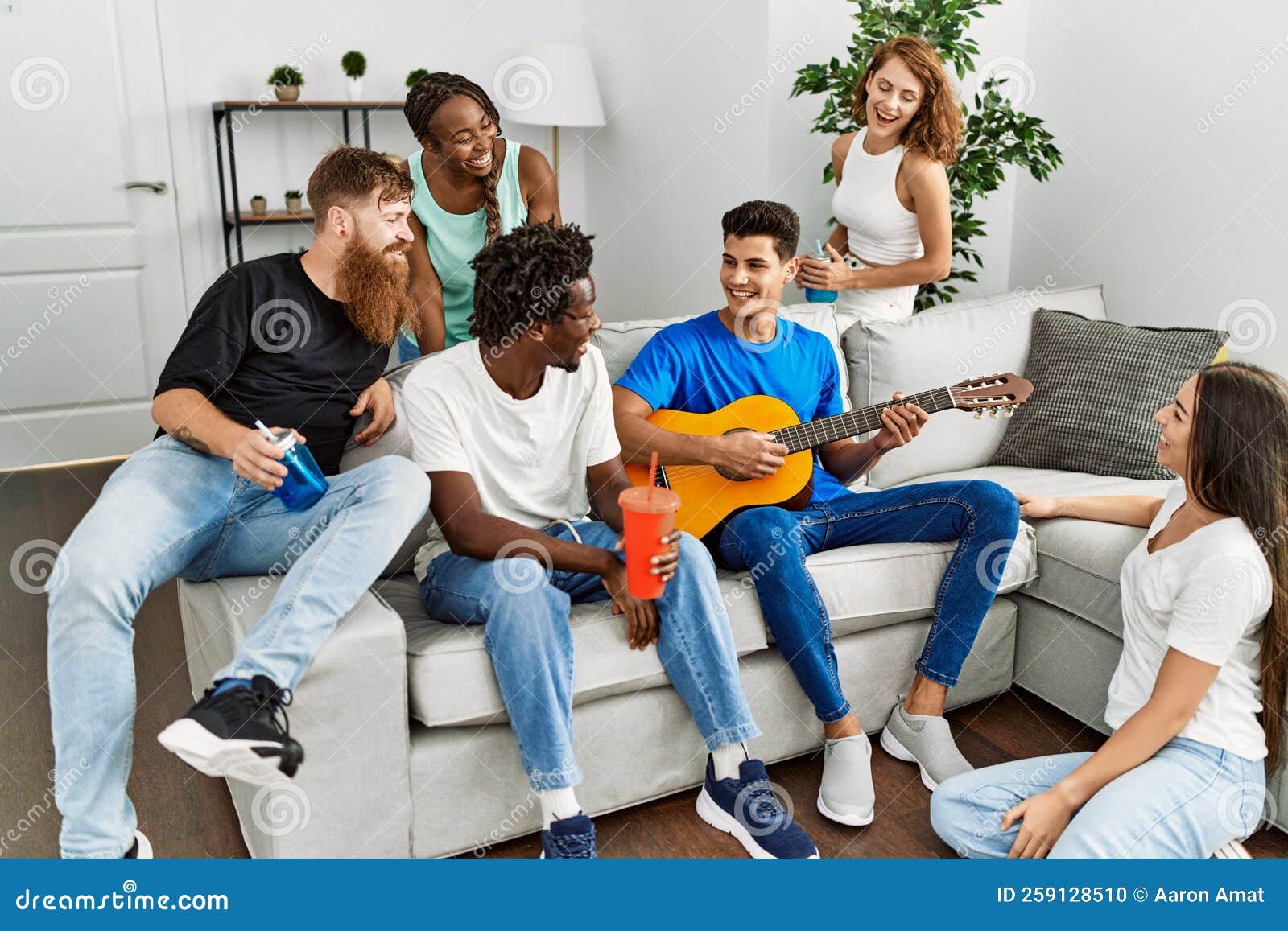 Group of Young Friends Smiling Happy and Playing Classical Guitar at ...
