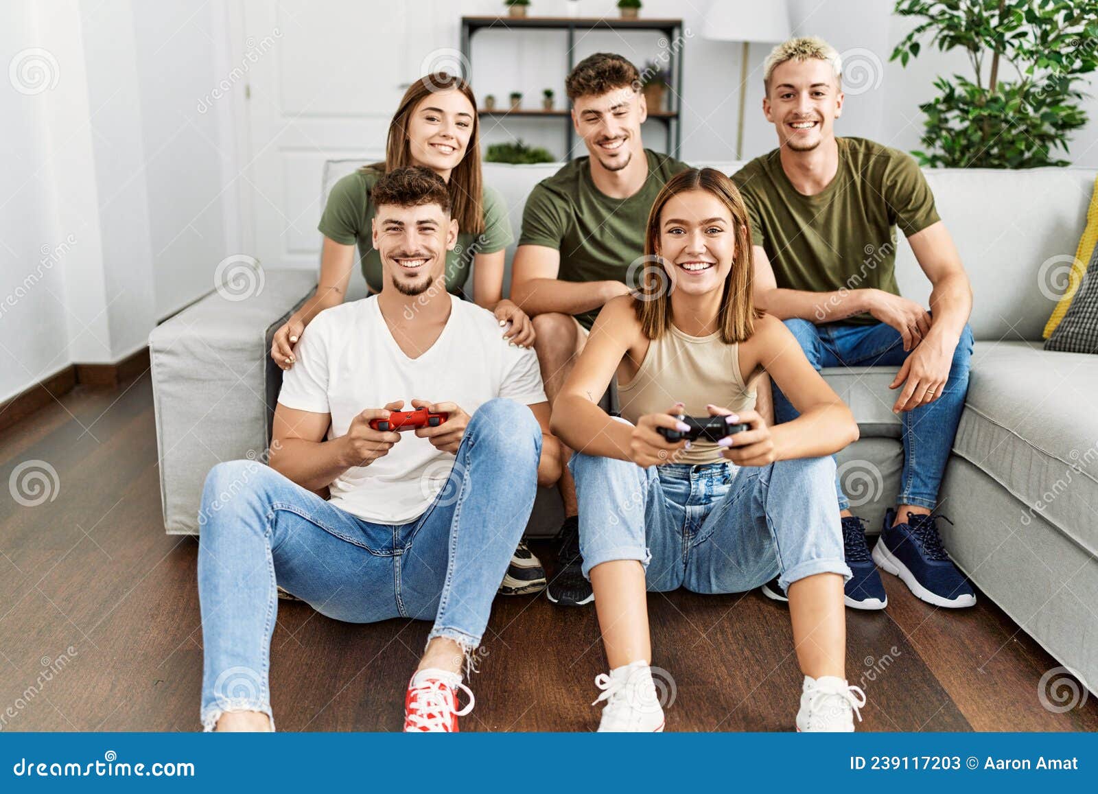 Group of Young Friends Smiling Happy Playing Video Game at Home Stock ...