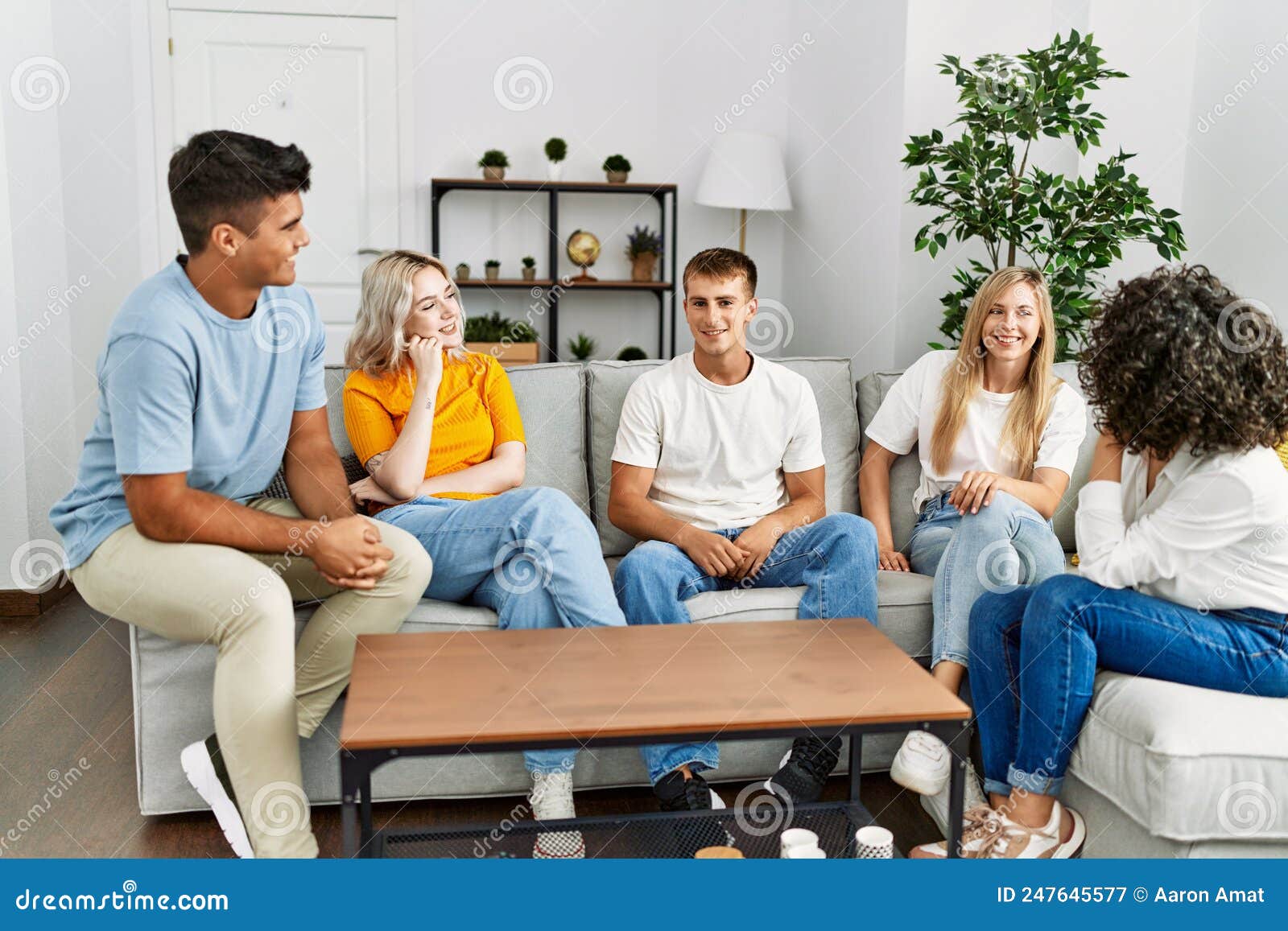Group of Young Friends Smiling Happy Sitting on the Sofa at Home Stock ...