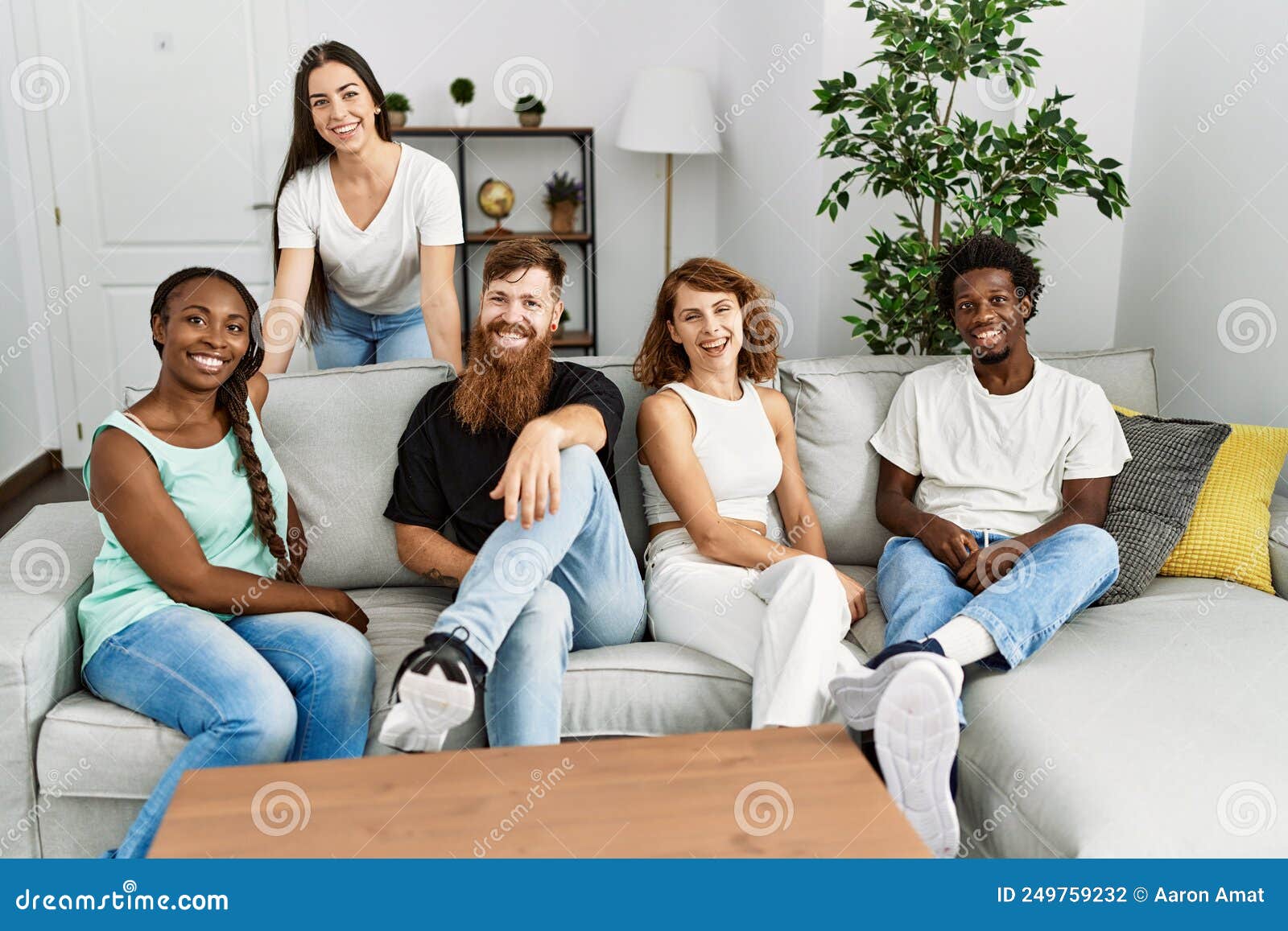 Group of Young Friends Smiling Happy Sitting on the Sofa at Home Stock ...