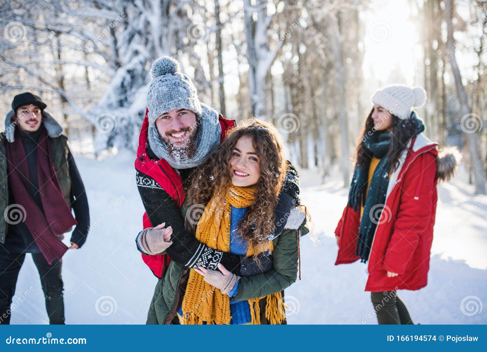 A Group of Young Friends on a Walk Outdoors in Snow in Winter Forest ...