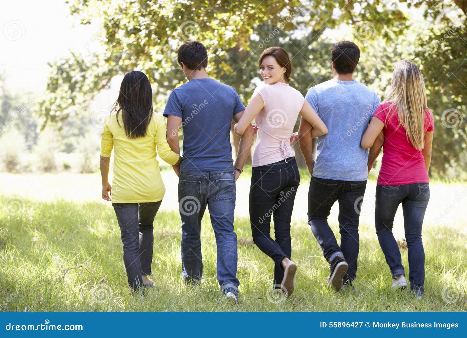 Group of Young Friends Walking through Countryside Stock Image - Image ...