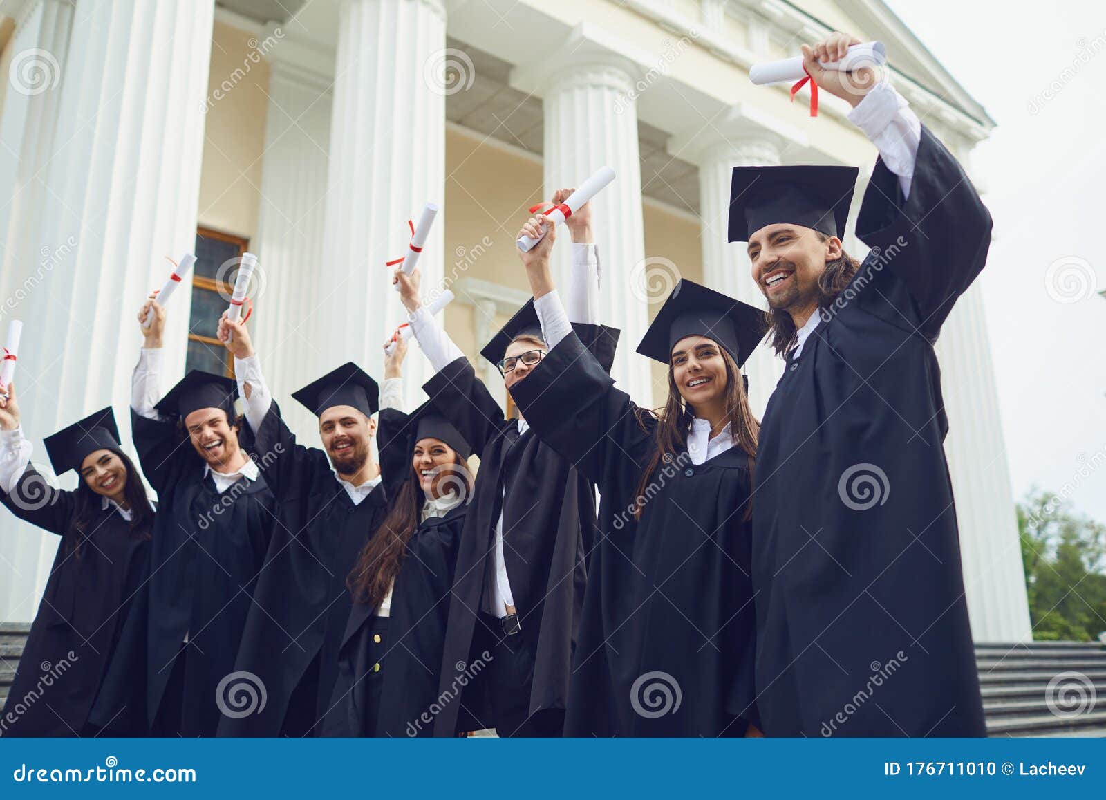 A Group of Graduate Students Raised Their Hands with Diplomas Up Stock ...