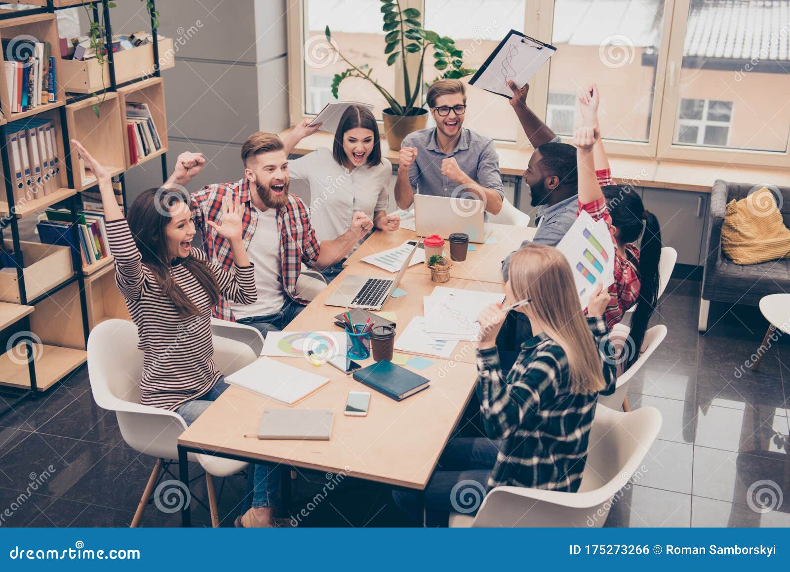 Group of Young Happy Managers Triumphing with Raised Hands Stock Photo ...