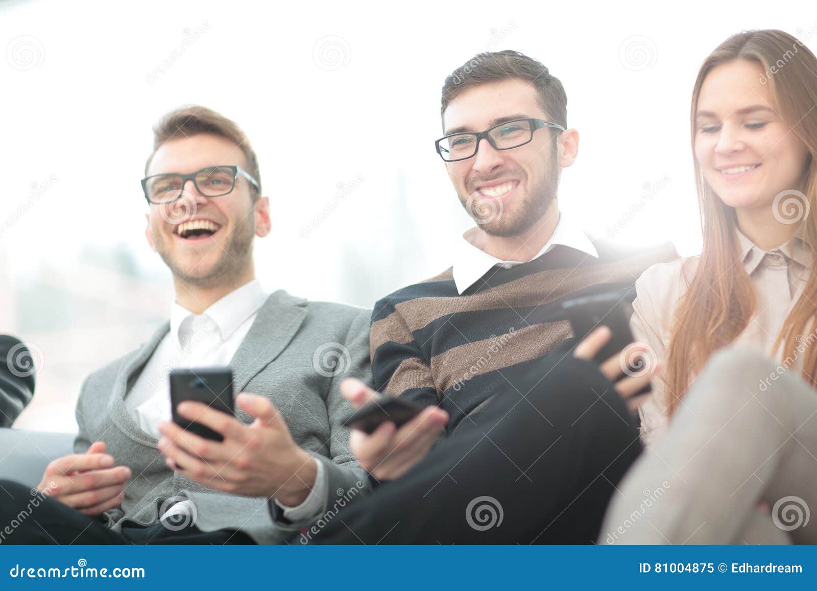 A Group of Young and Happy Young People Using Their Phones and C Stock ...
