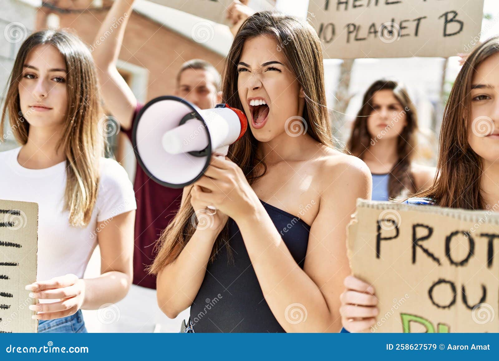 Group of Young Hispanic Activists Protesting Holding Banner and Using ...