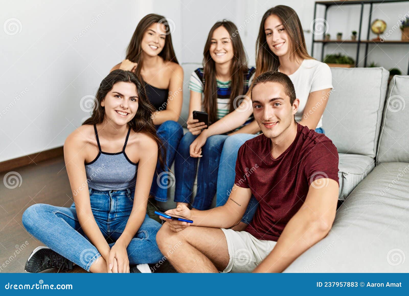 Group of Young Hispanic Friends Smiling Happy Using Smartphone Sitting ...