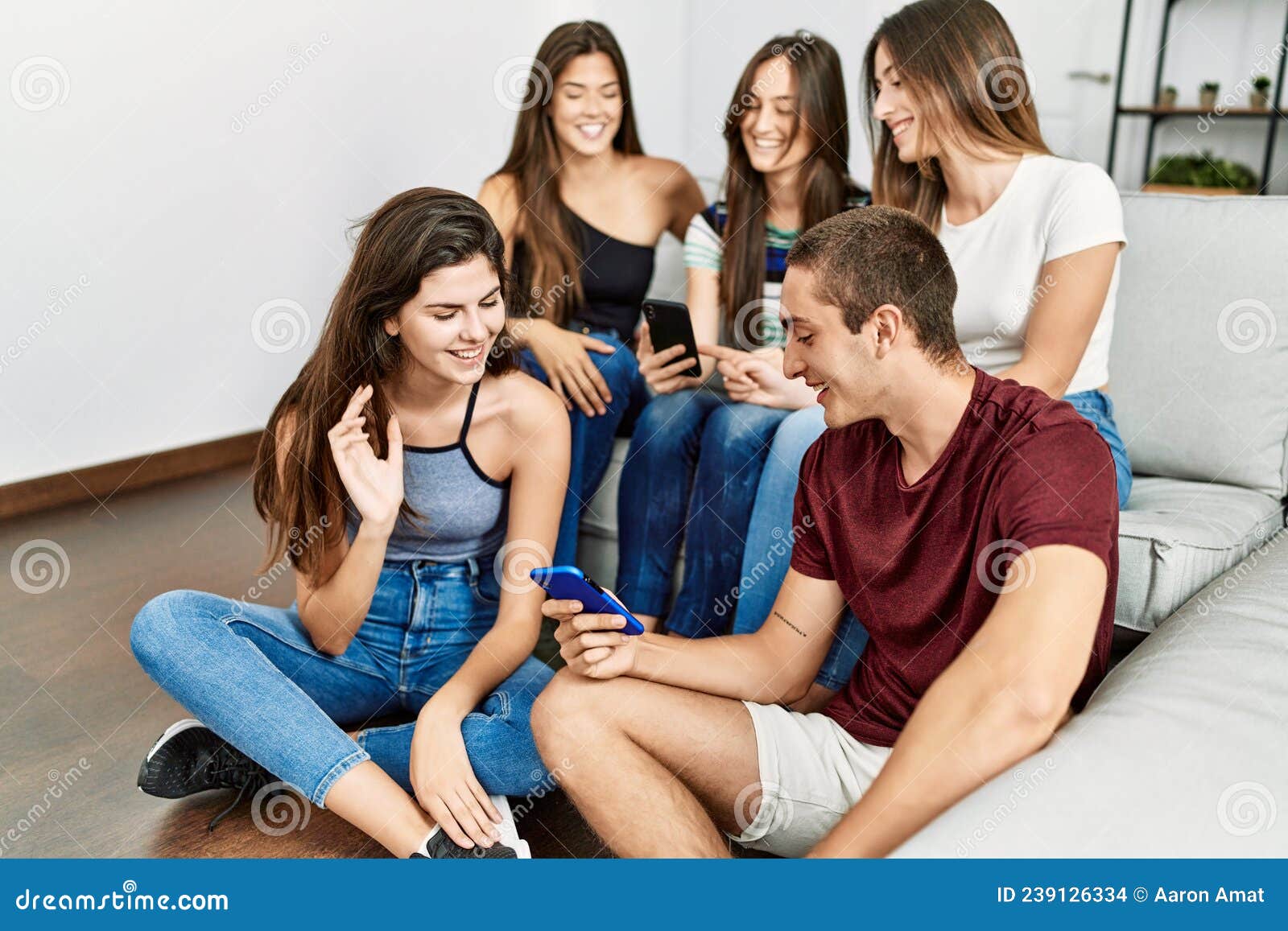 Group of Young Hispanic Friends Smiling Happy Using Smartphone Sitting ...