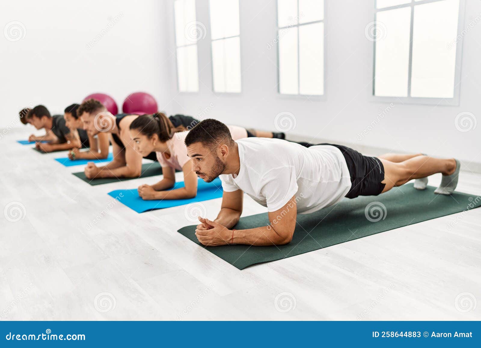 Group of Young Hispanic People Concentrate Training Abdominal Exercise ...