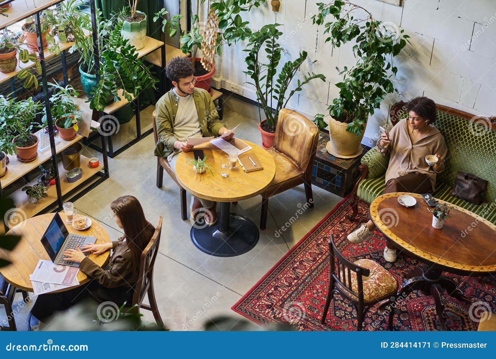 Group of Young Intercultural Analysts or Brokers Working in Cafe Stock ...