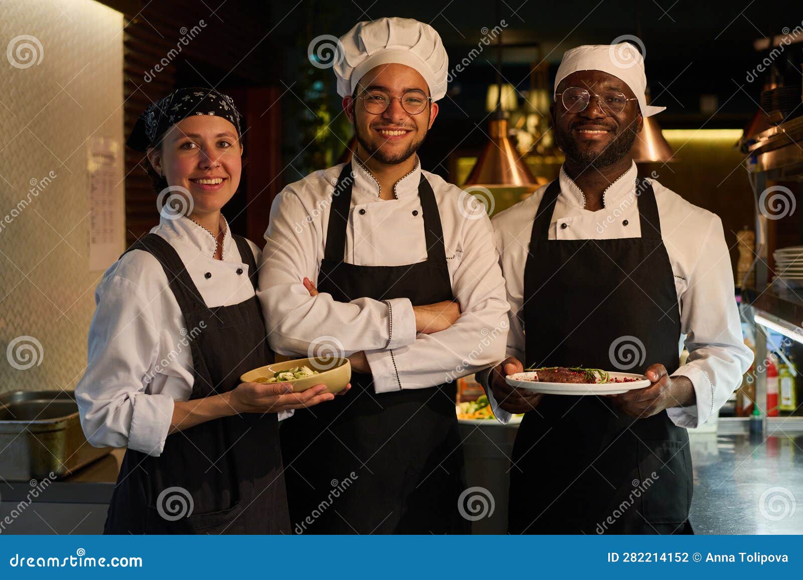 Group of Young Intercultural Successful Cooks in Uniform Looking at ...