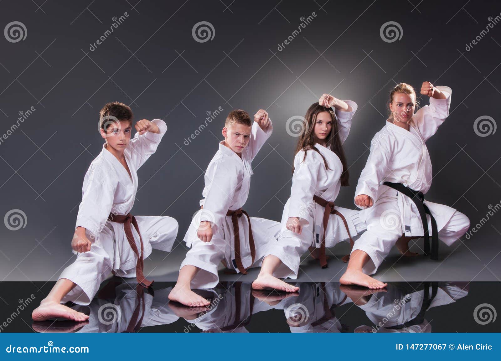 Group Of Young Karate Players Doing Kata On The Gray Background Stock ...