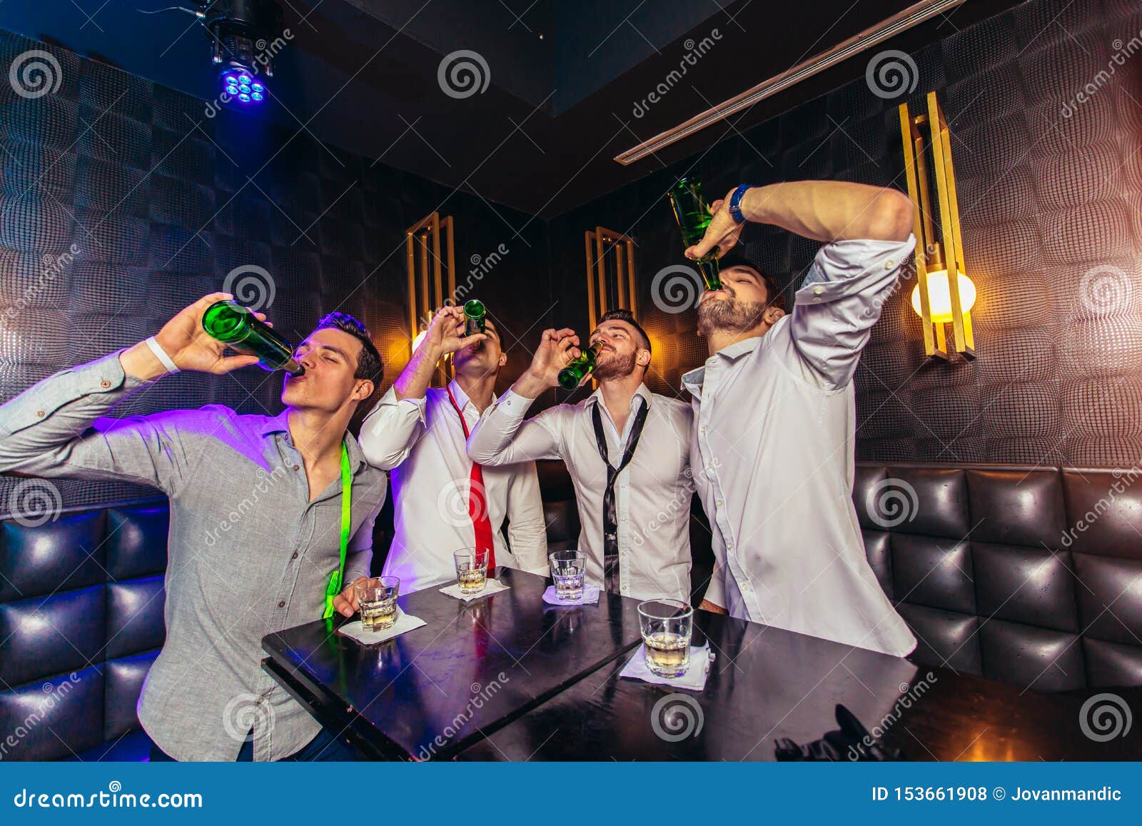 Young Men Toasting at a Nightclub Stock Photo - Image of mouth, drunk ...