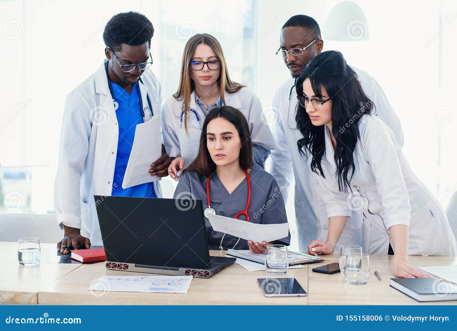 Group of Young Multi National Doctors during Working with Laptop in the ...