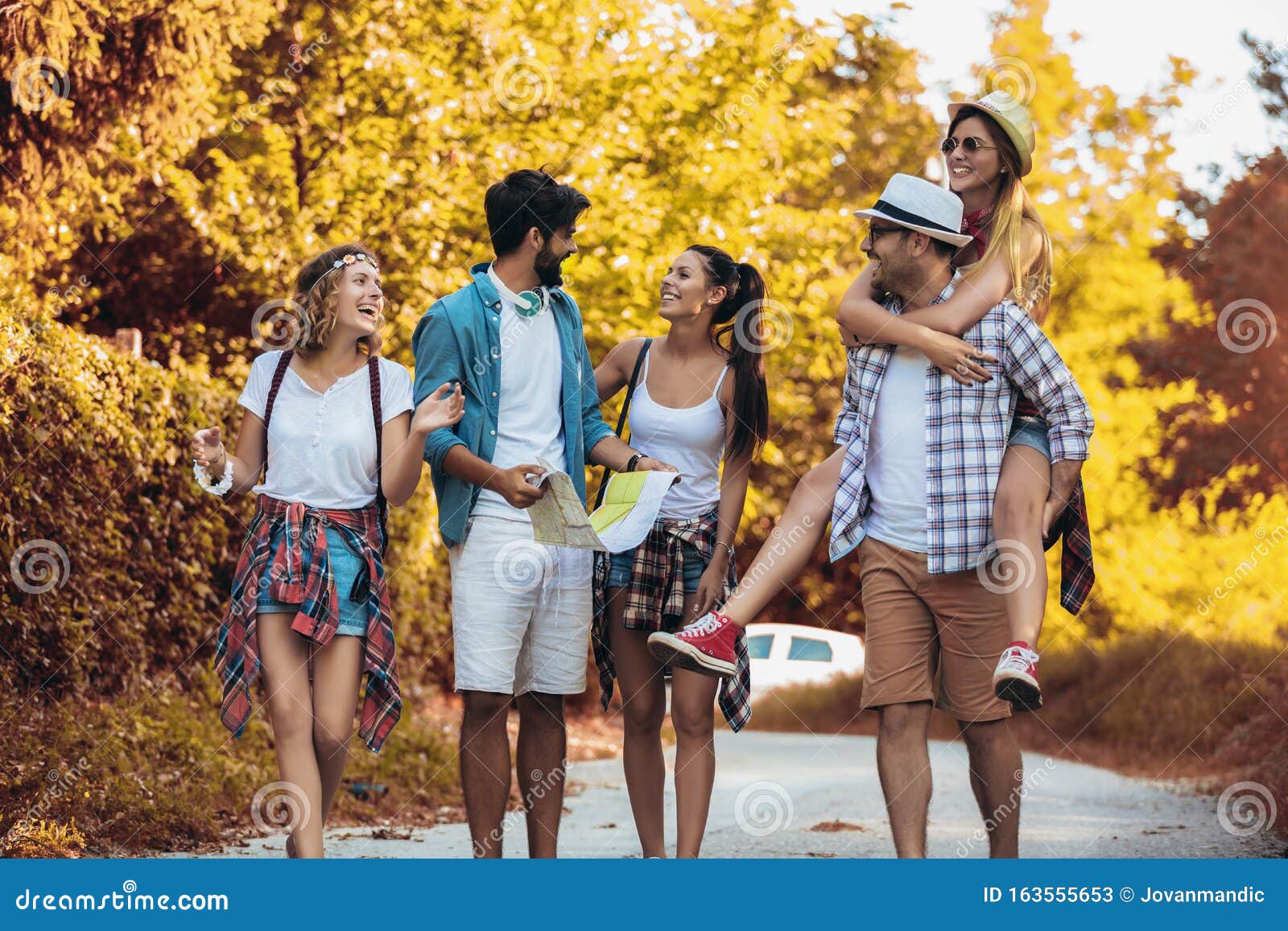 Young People with Backpacks Walking Together and Looking Happy Stock ...