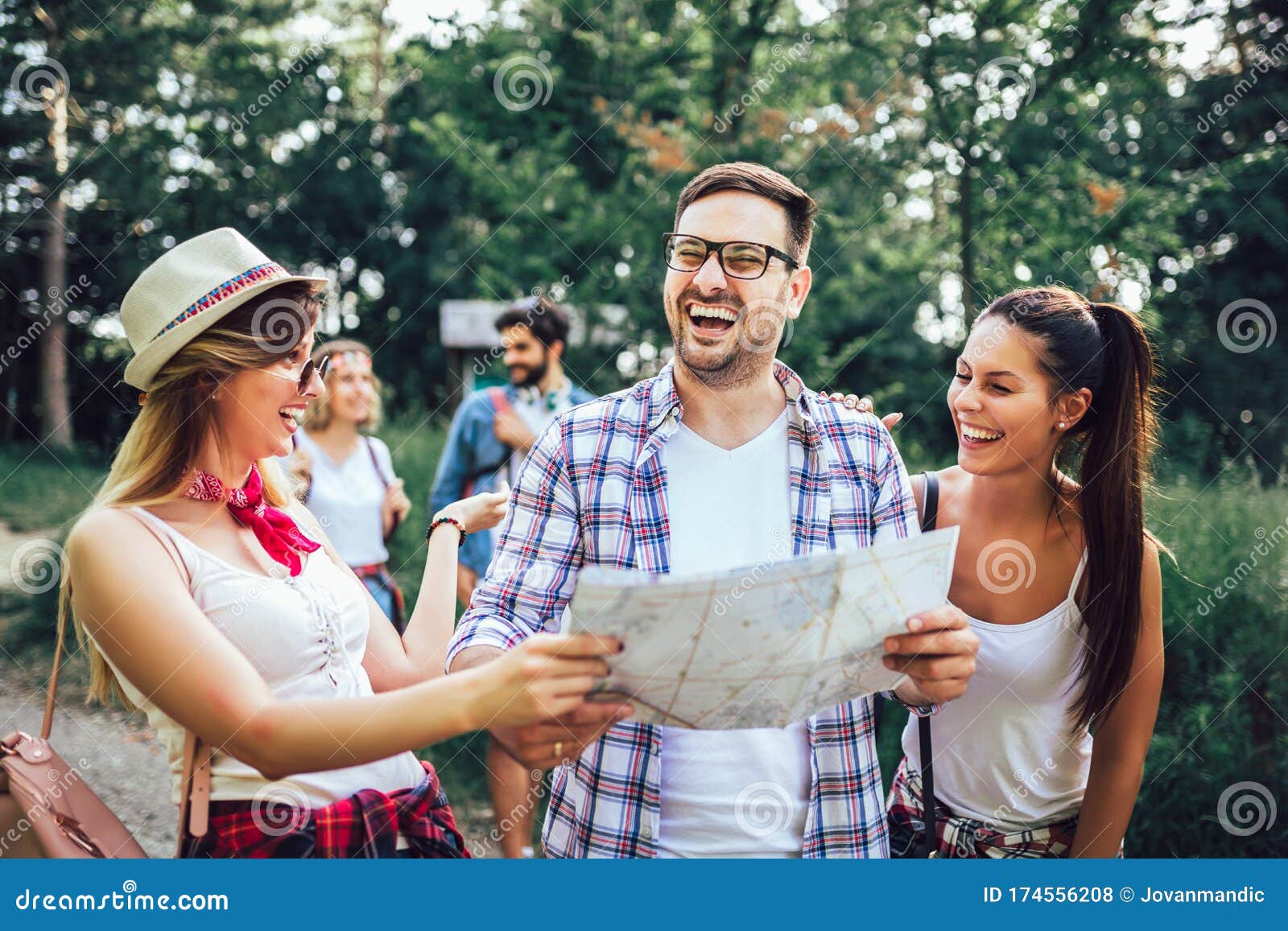 Young People with Backpacks Walking Together by the Road and Looking ...