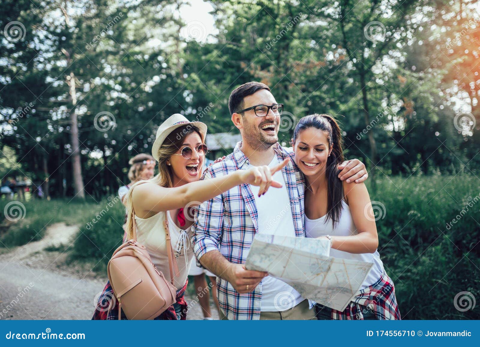Young People with Backpacks Walking Together by the Road and Looking ...