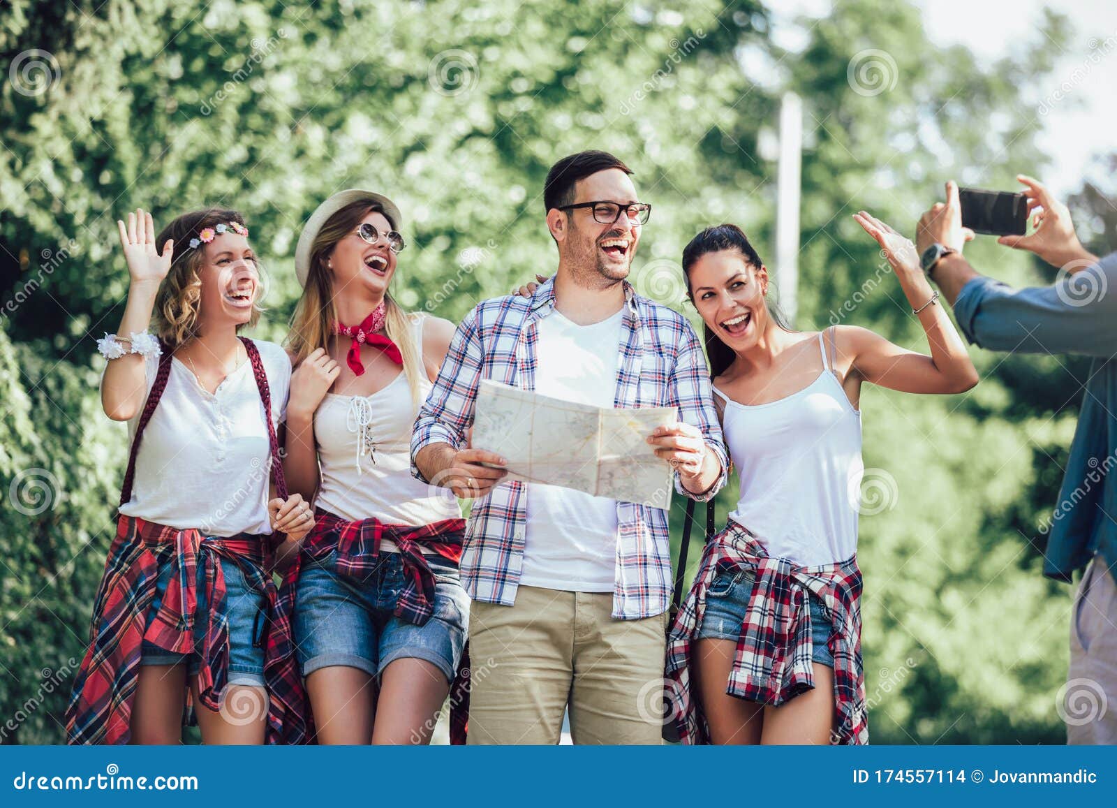 Young People with Backpacks Walking Together by the Road and Looking ...