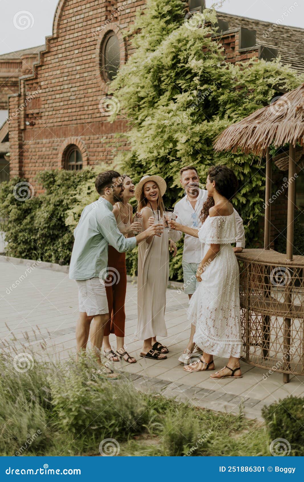 Group of Young People Cheering and Having Fun Outdoors with Drinks ...