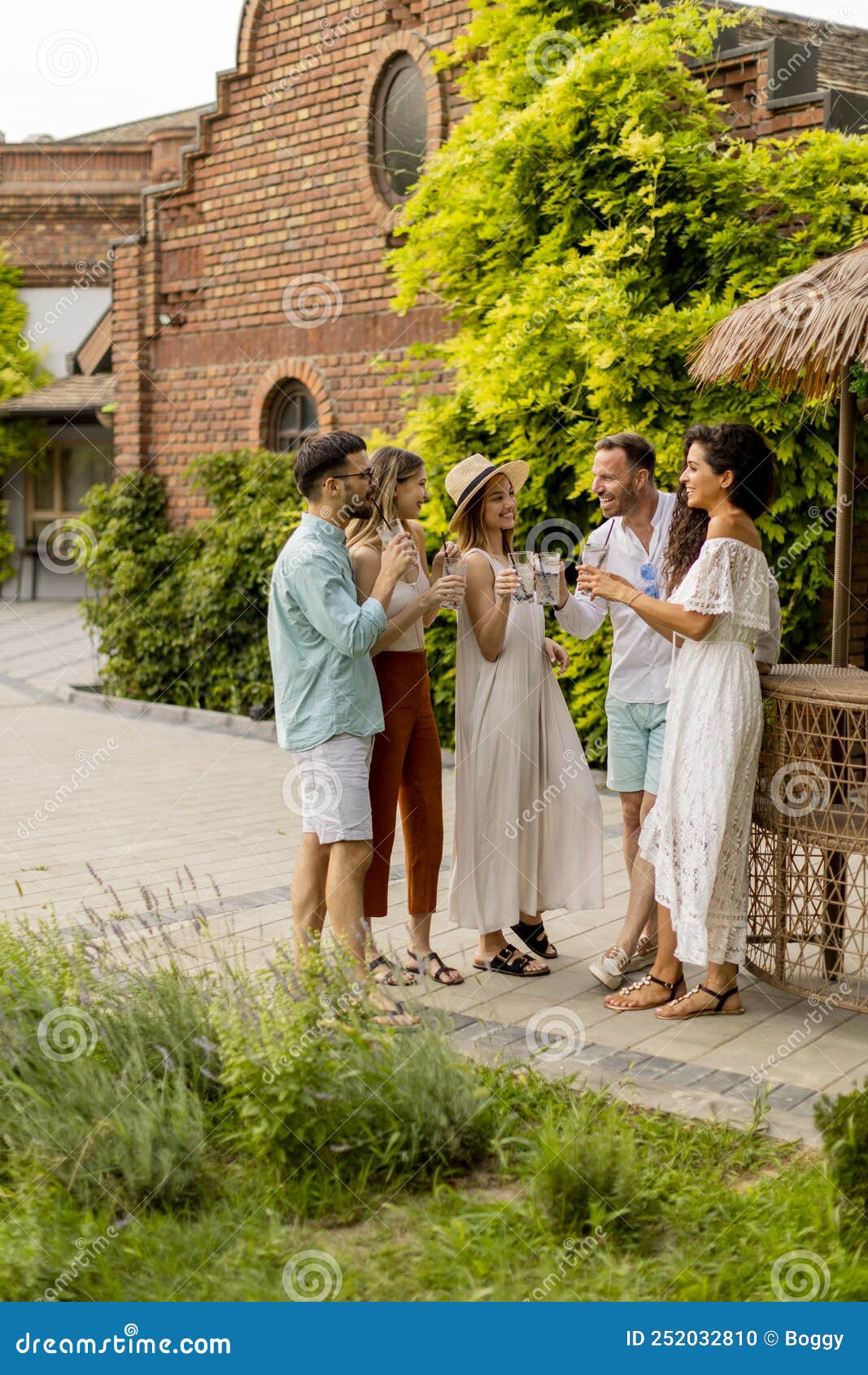 Group of Young People Cheering and Having Fun Outdoors with Drinks ...