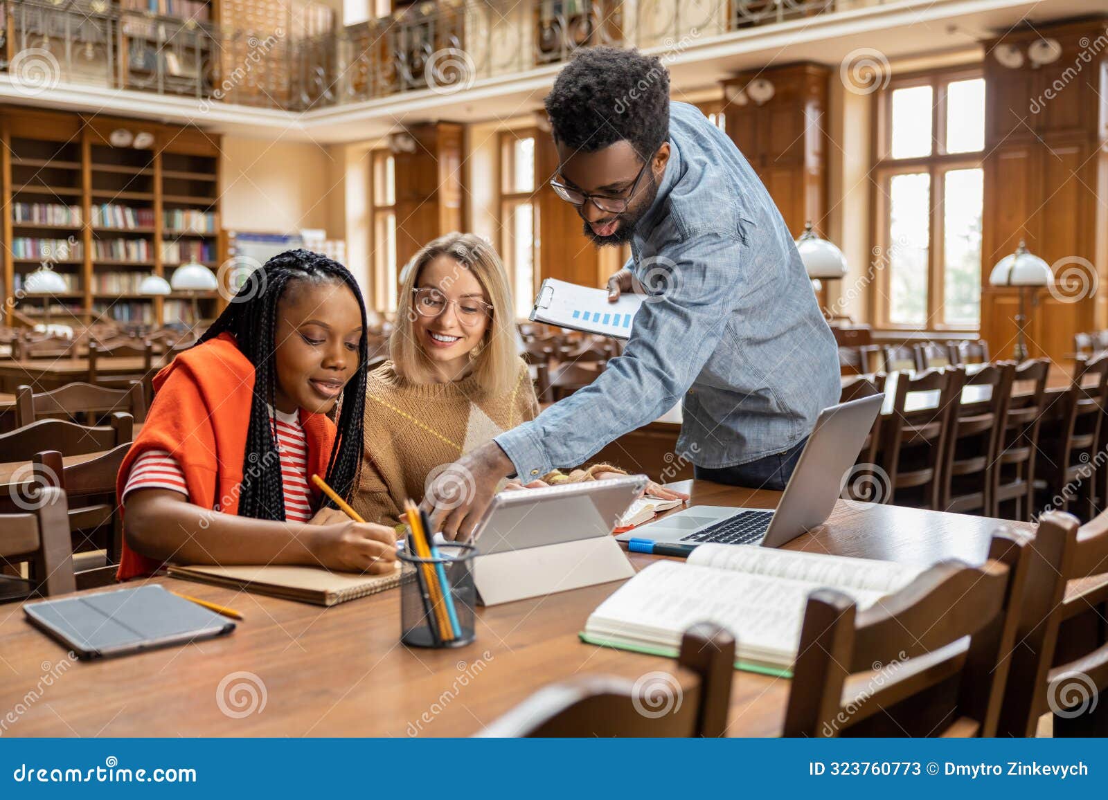 Group of Young People Discussing Something in the Library Stock Image ...