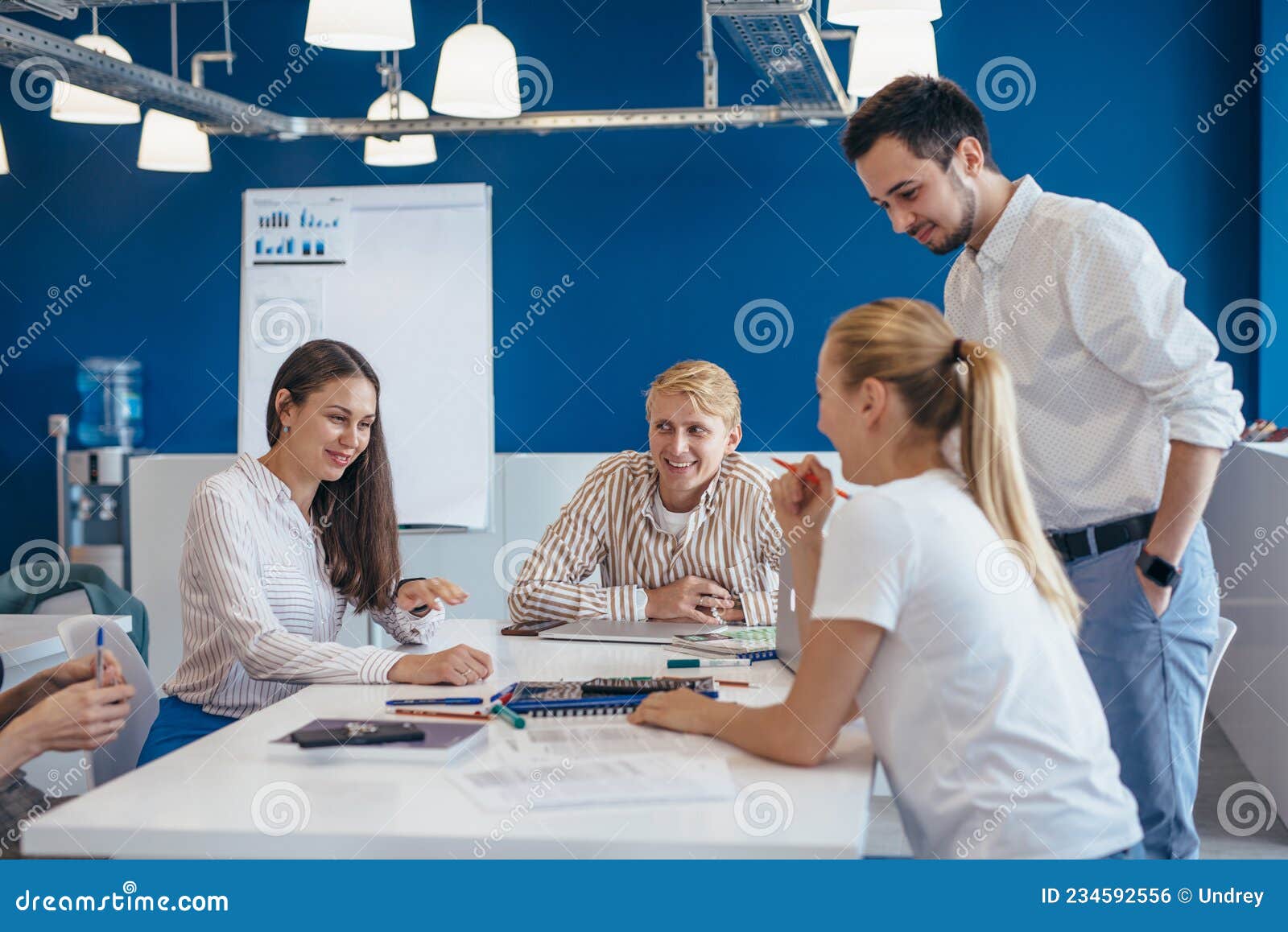 Group of Young People Gather Around Table and Talk while they Work ...