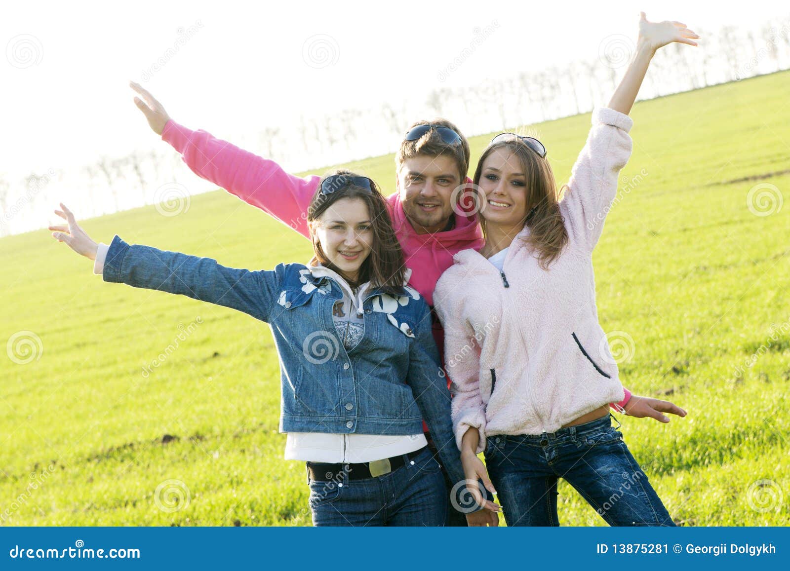 Group of Young People on a Green Field Stock Image - Image of cheerful ...