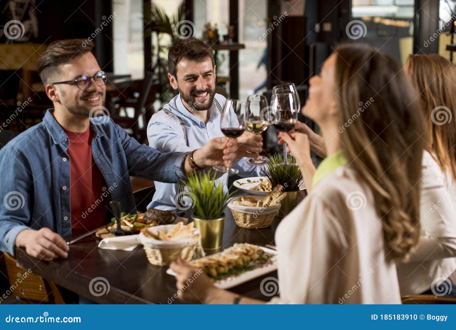 Group of Young People Having Dinner in the Restaurant Stock Photo ...