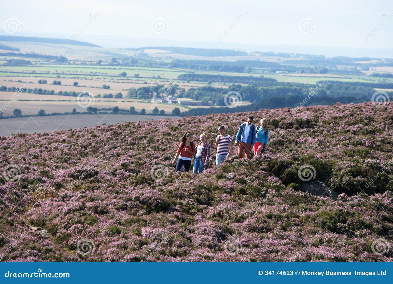 Group of Young People Hiking through Countryside Stock Image - Image of ...