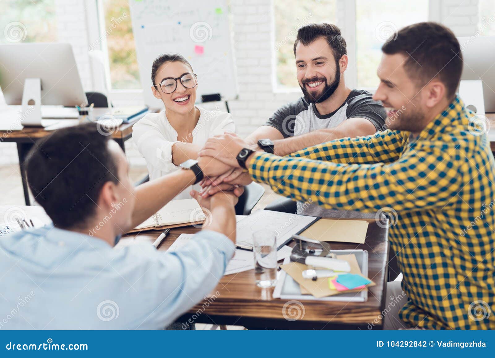A Group of Young People Discussing Something in the Office. they are ...