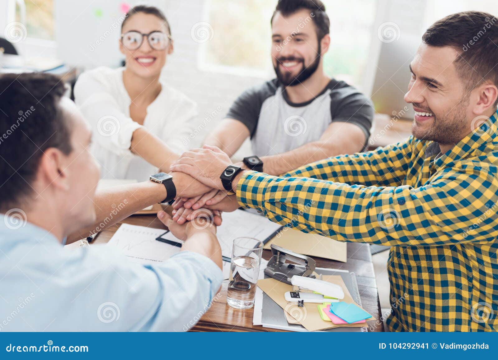 A Group of Young People Discussing Something in the Office. they are ...