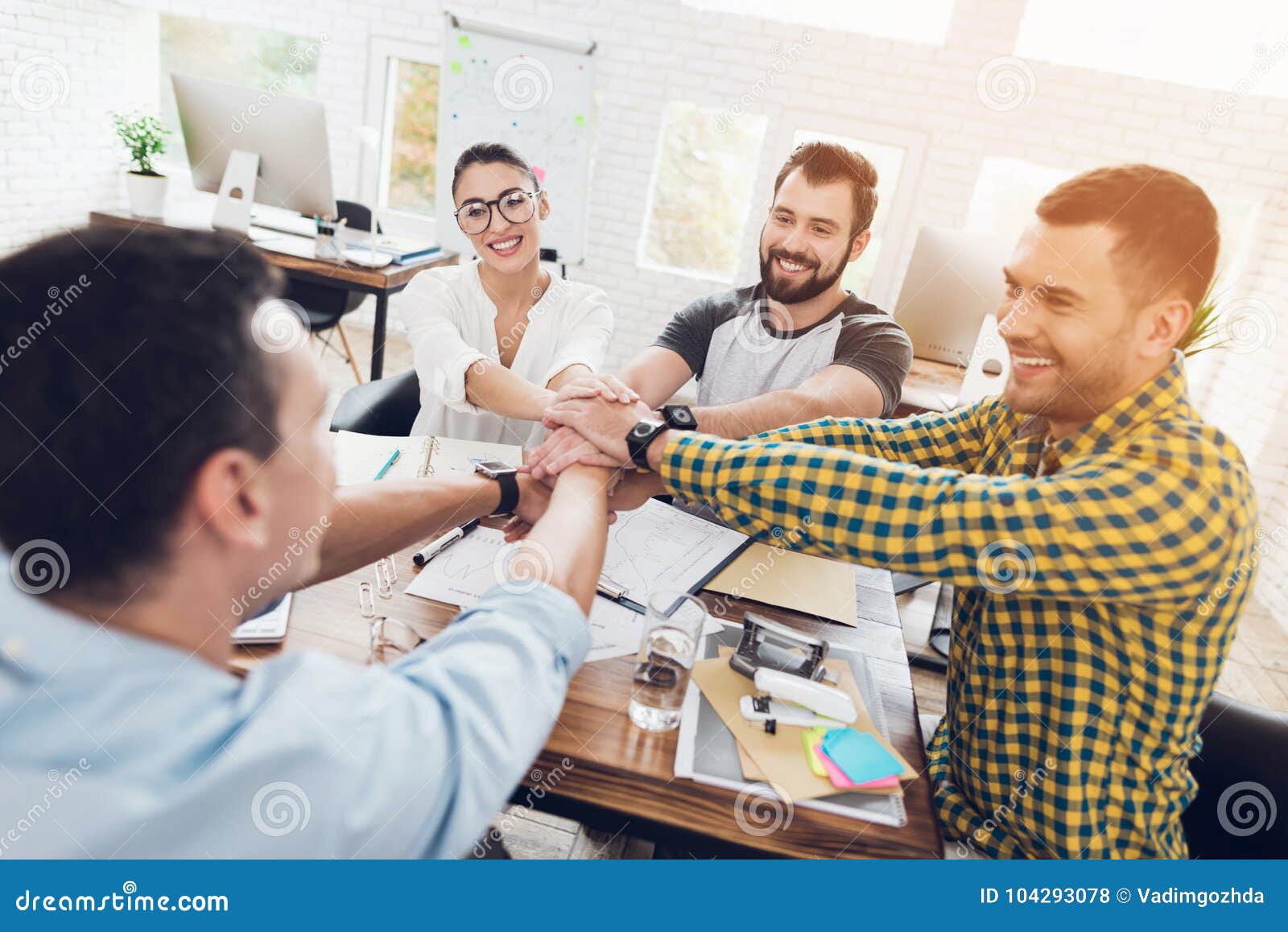 A Group of Young People Discussing Something in the Office. they are ...