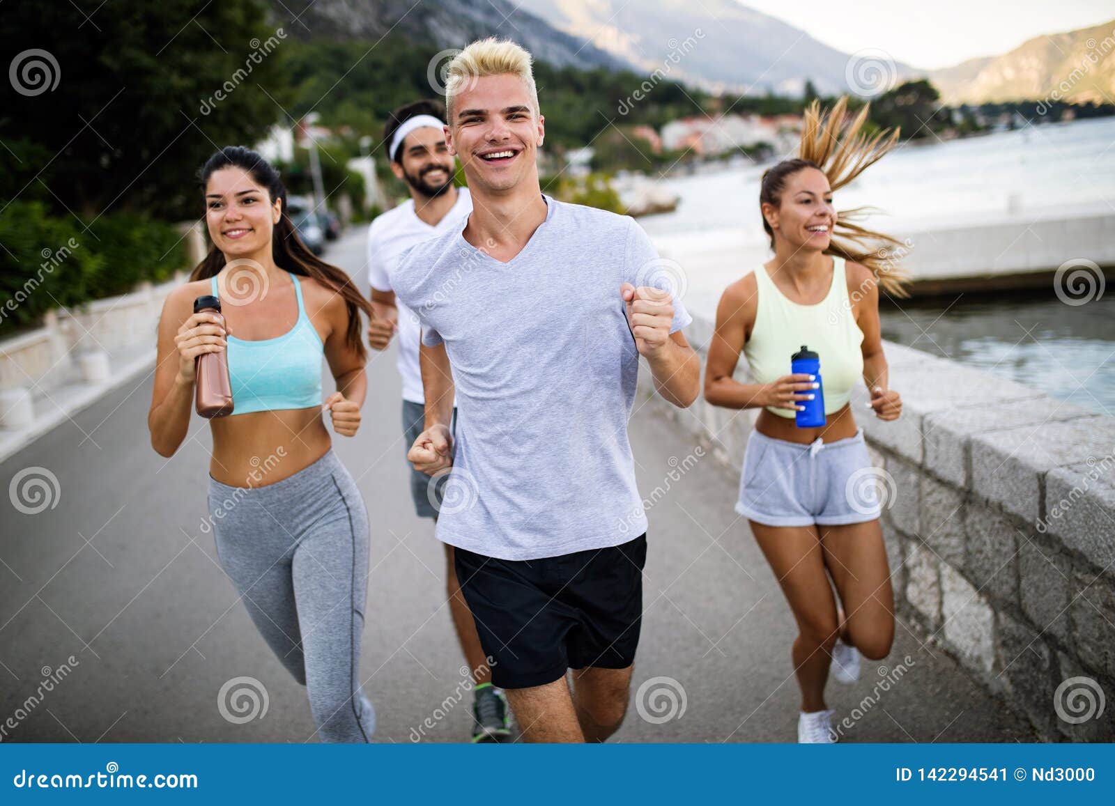Group of Young People Jogging and Running Outdoors in Nature Stock ...