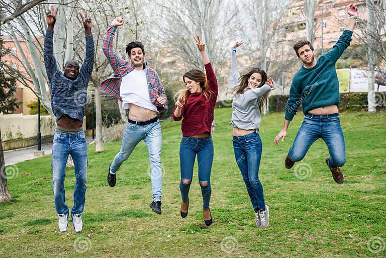 Group of Young People Jumping Together Outdoors Stock Photo - Image of ...
