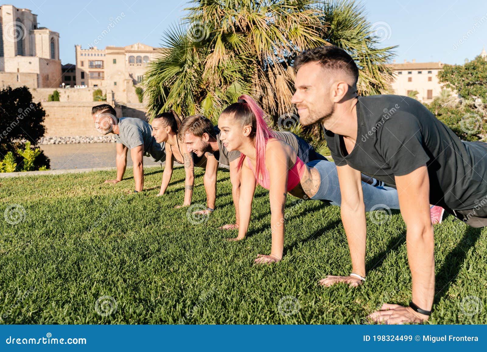 Group of Young People Practicing Plank Exercise Stock Image - Image of ...