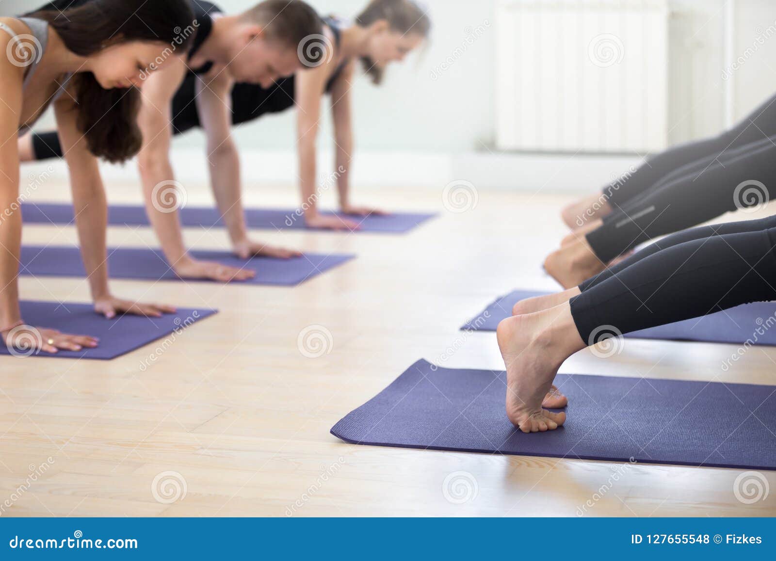 Group of Young People Practicing Yoga, Plank Pose Close Up Stock Photo ... Group of Young People Practicing Yoga, Plank Pose Close Up Stock Photo ...