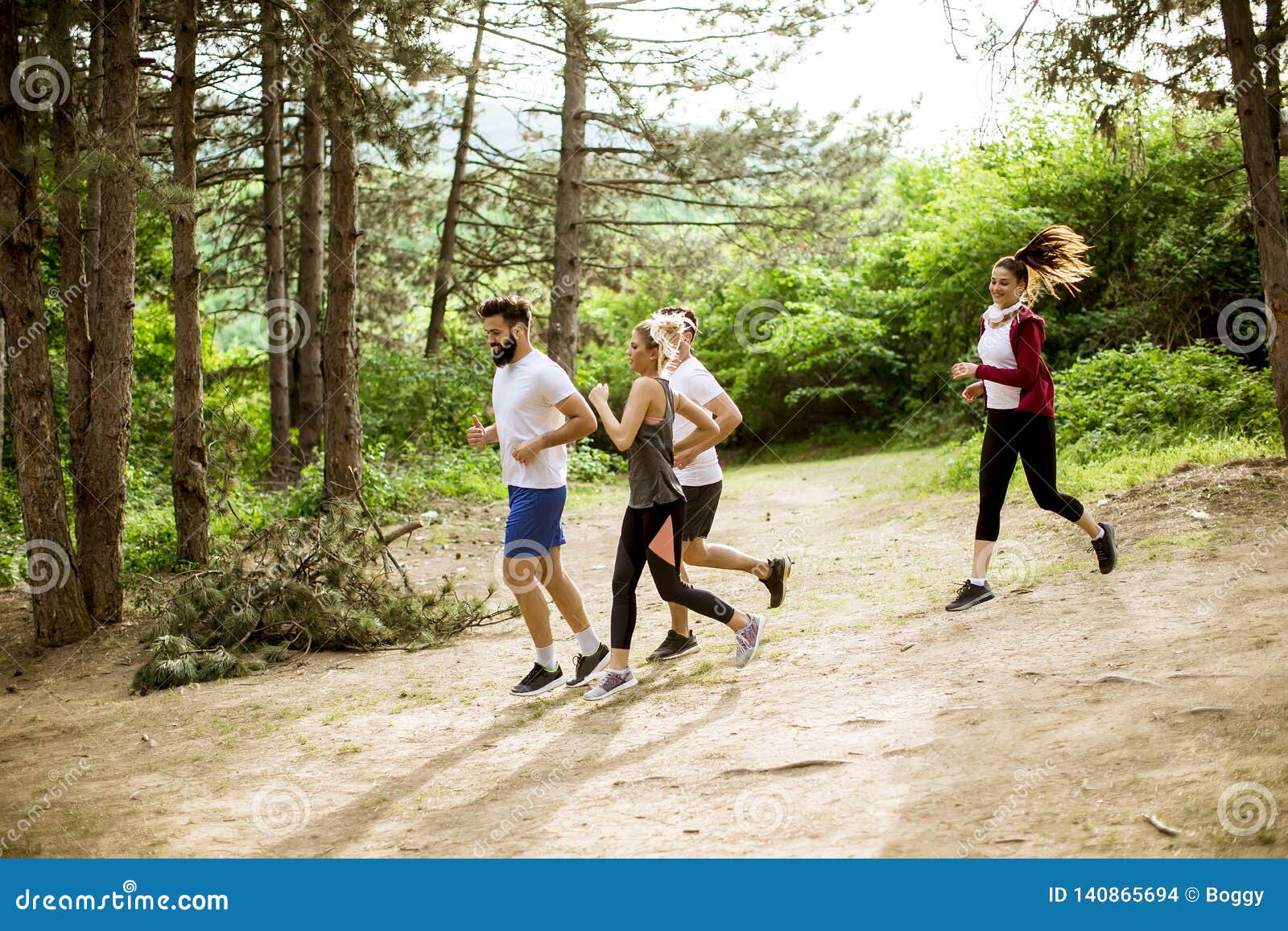 Group of Young People Run a Marathon through the Forest Stock Photo ...