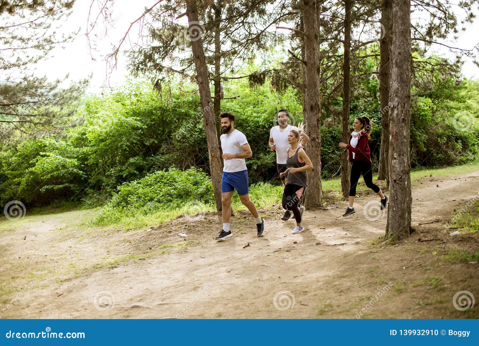Group of Young People Run a Marathon through the Forest Stock Photo ...