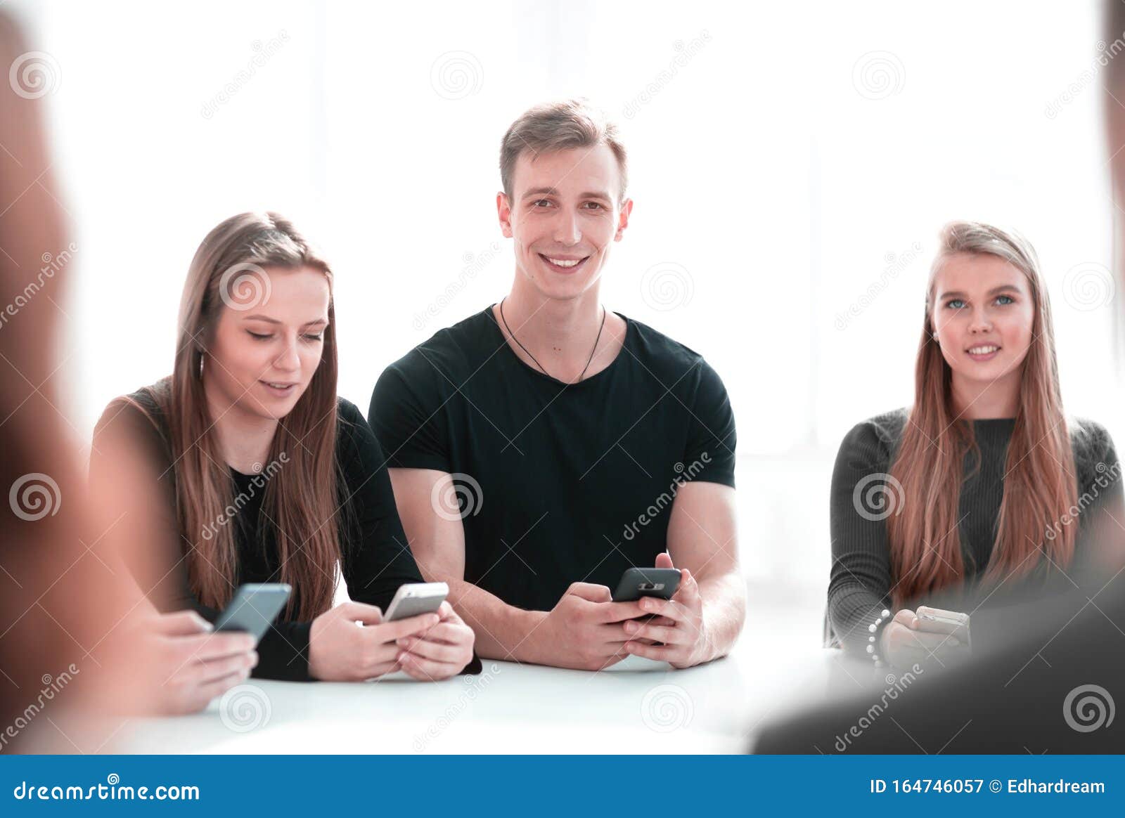 Group of Young People Sitting at a Round Table Stock Image - Image of ...